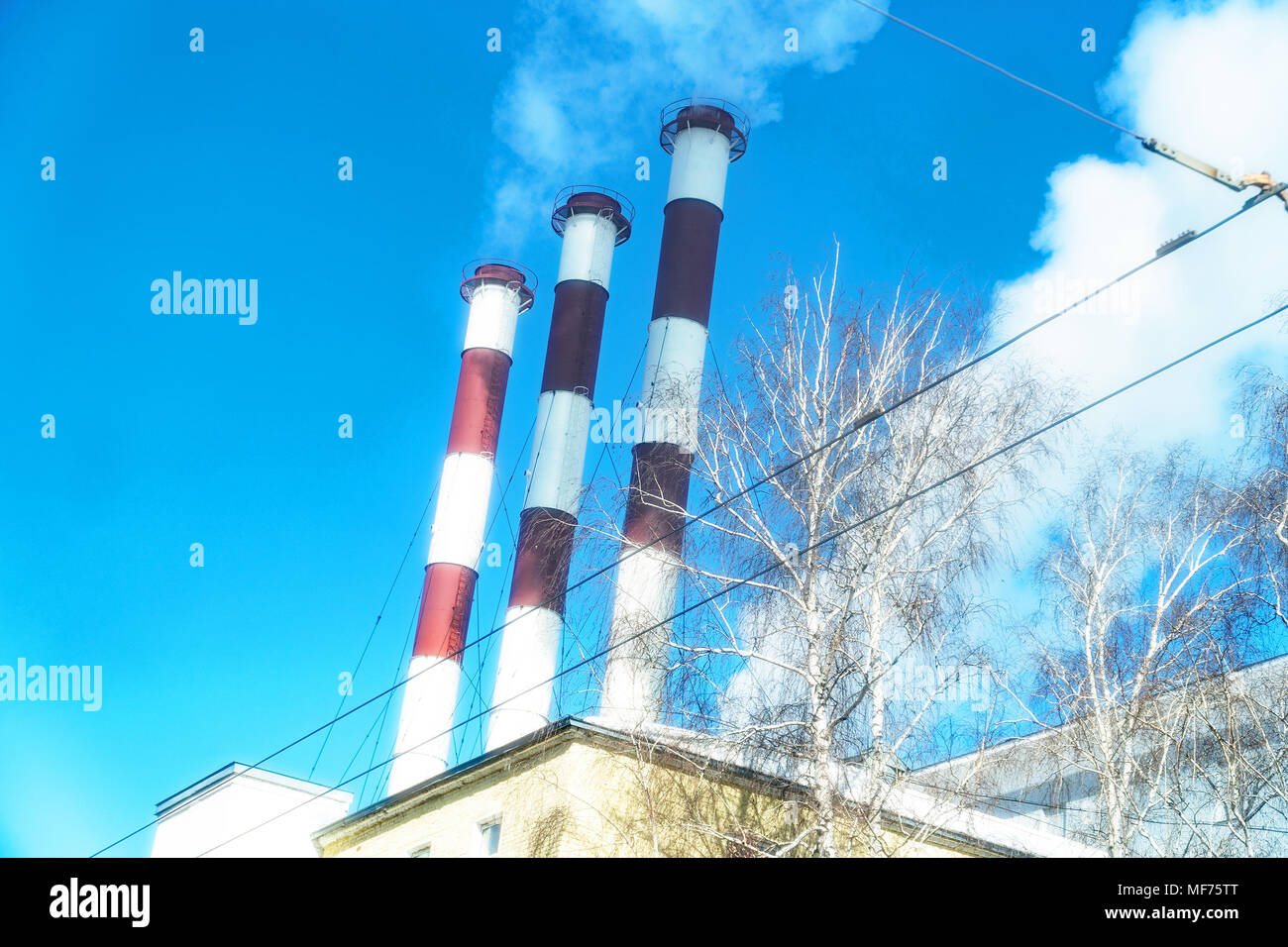 Three factory pipes smoke Stock Photo - Alamy