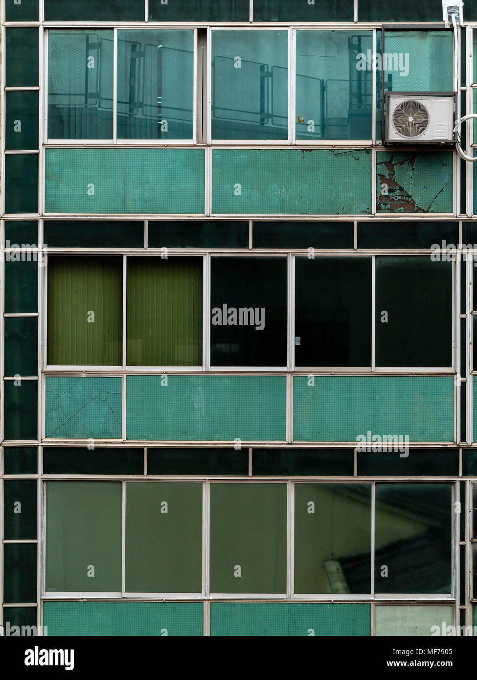old green glass facade of an commercial building at sao paulo downtown ...
