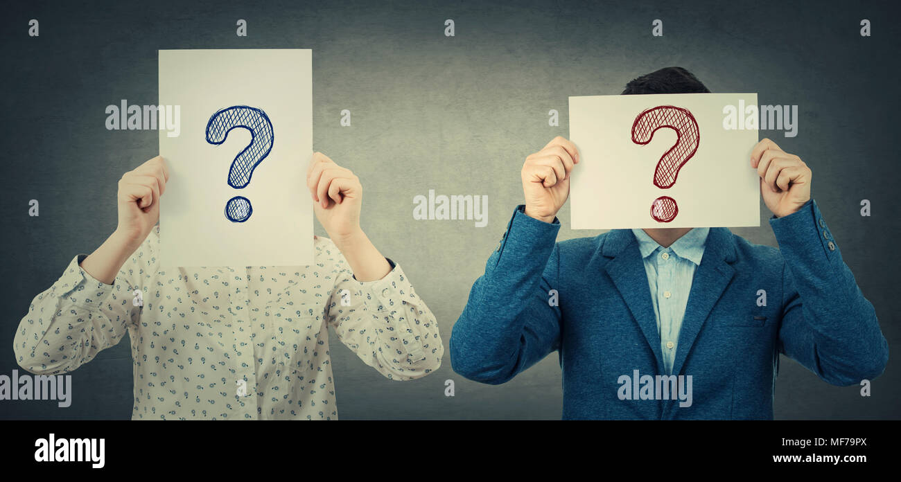 Businessman and businesswoman covering their faces using white paper ...