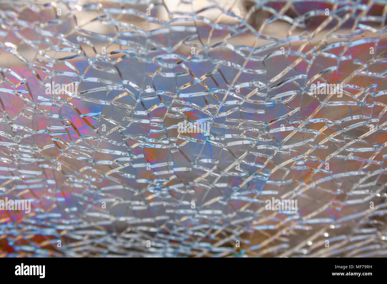 Close-up of shattered tempered glass against the color background Stock ...