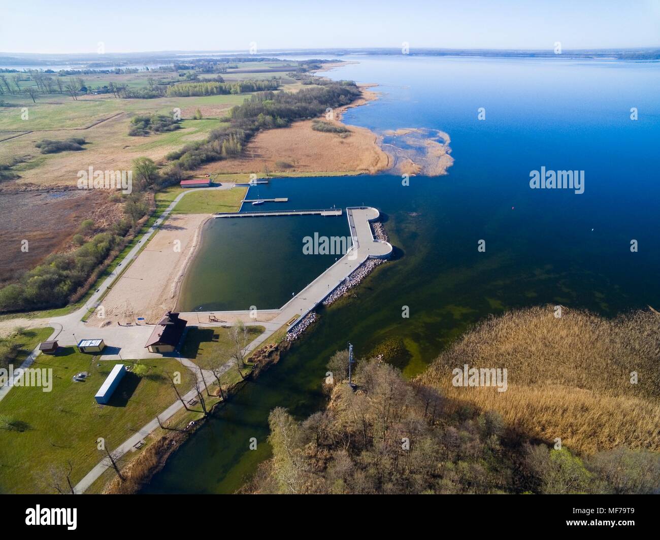 Aerial view of the beach on Mamry lake shore by Wegorapa river estuary ...