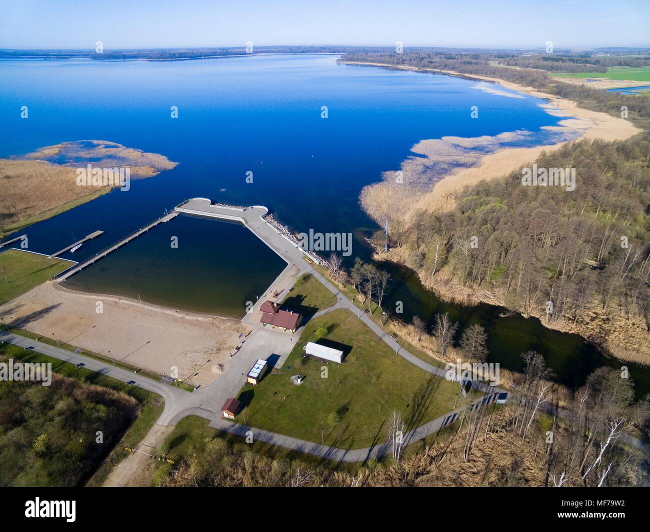 Aerial view of the beach on Mamry lake shore by Wegorapa river estuary ...