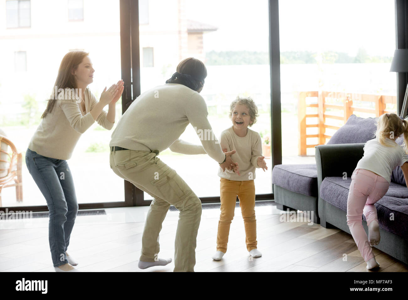 Happy family with children playing hide and seek game together Stock ...