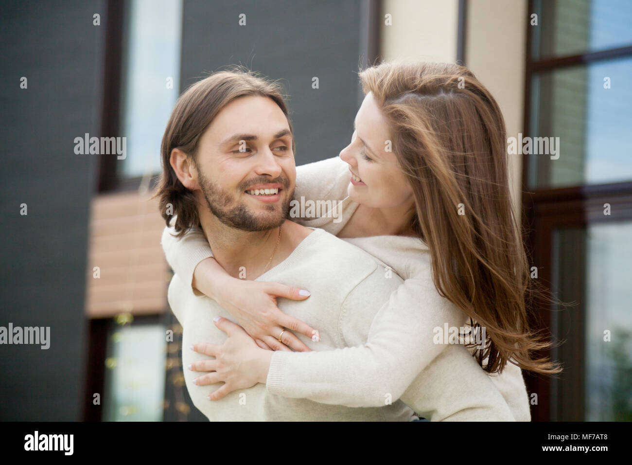 Loving young happy couple embracing outdoor, smiling husband pig Stock ...