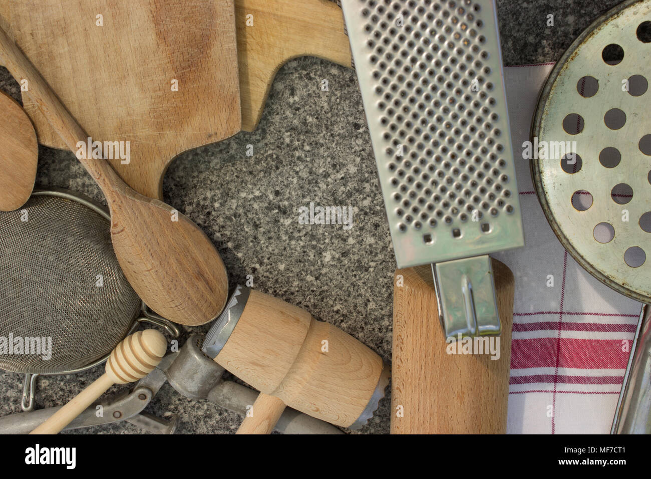 Rural kitchen utensils on vintage planked wood table from above ...