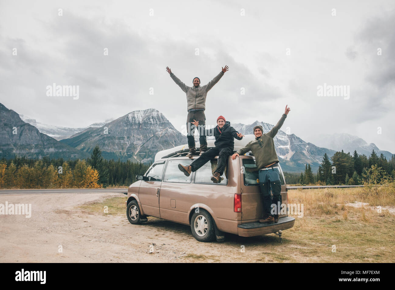 Canada, Alberta, Banff National Park, happy friends with minivan at ...