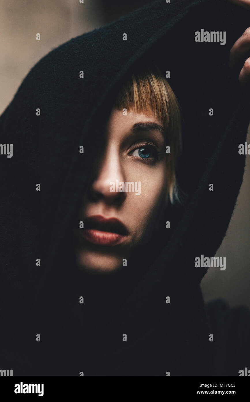 Portrait of woman with black hood Stock Photo - Alamy