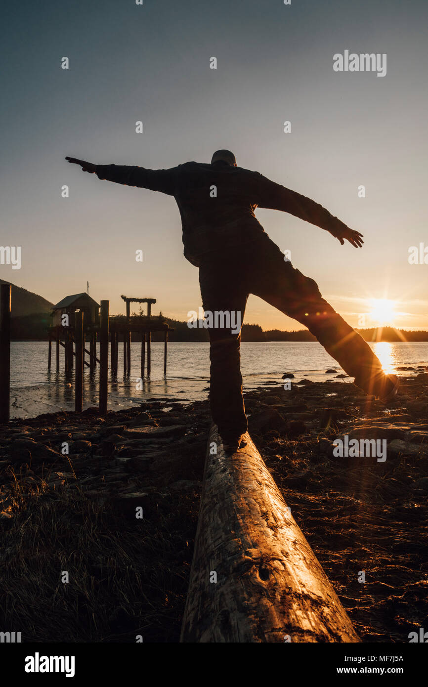 Man balancing on log at sunset hi-res stock photography and images - Alamy