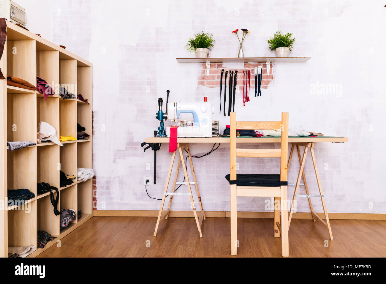 Workspace with sewing machine on table in studio Stock Photo - Alamy