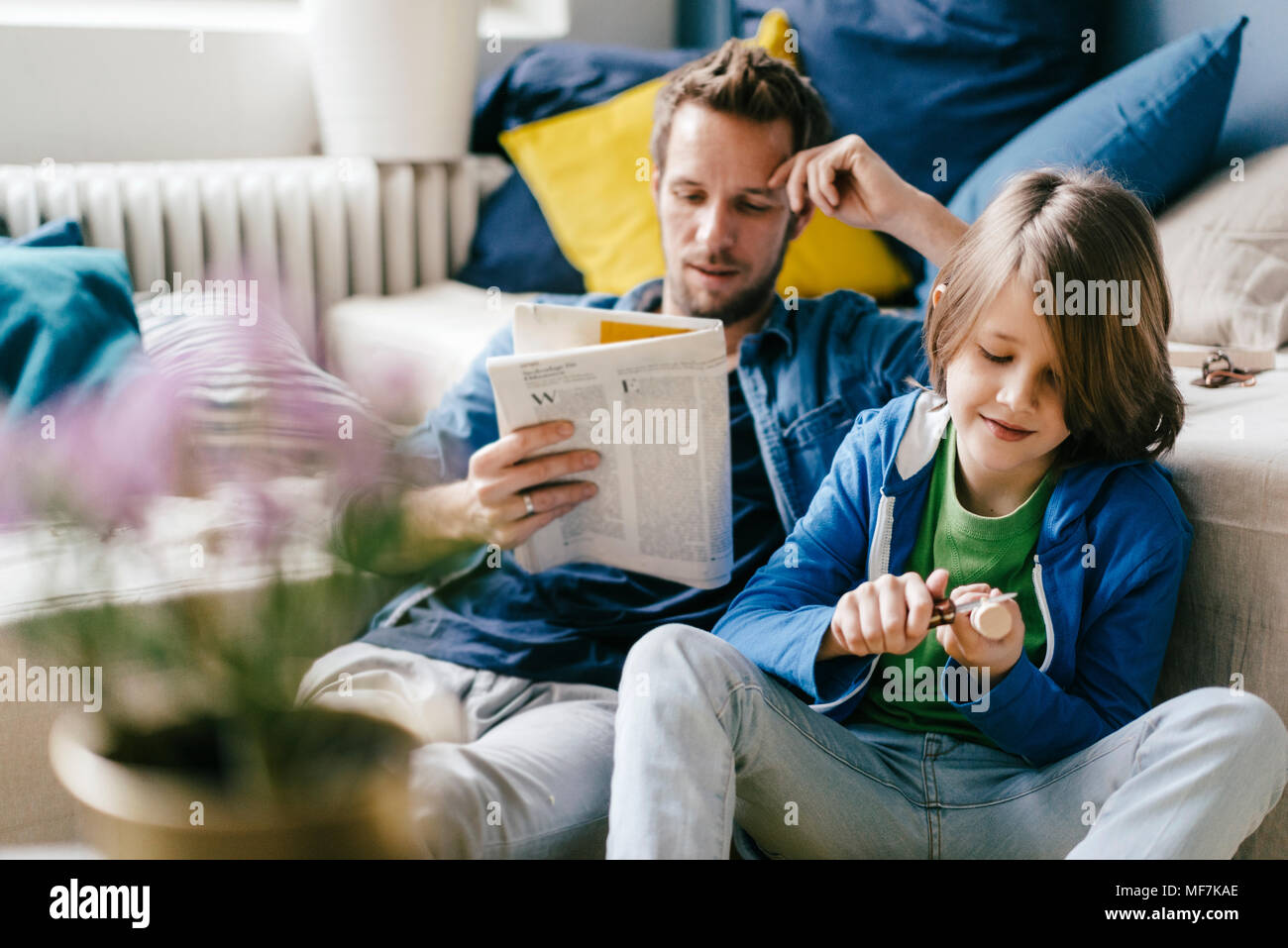 Father reading newspaper son carving home hi-res stock photography and ...