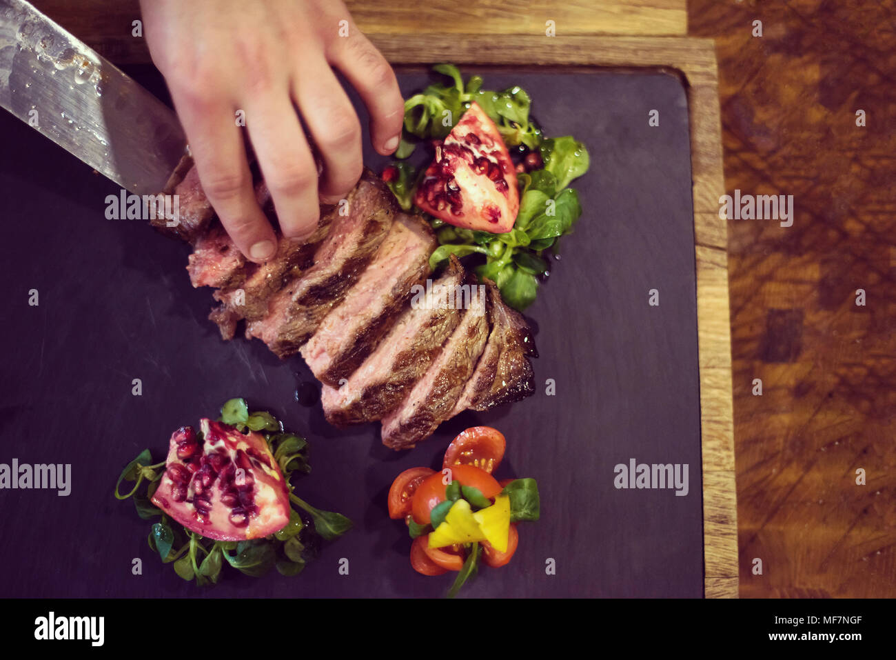 top view of Chef hands in hotel or restaurant kitchen serving beef ...