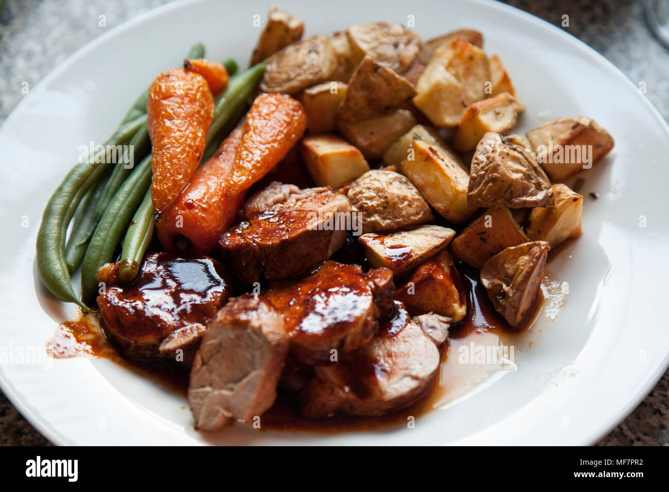 Caramelised pork fillet with baby carrots, green beans and potatoes ... Caramelised pork fillet with baby carrots, green beans and potatoes ...