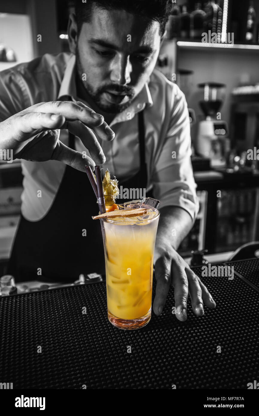 Bartender decorating non-alcoholic orange cocktail Stock Photo - Alamy