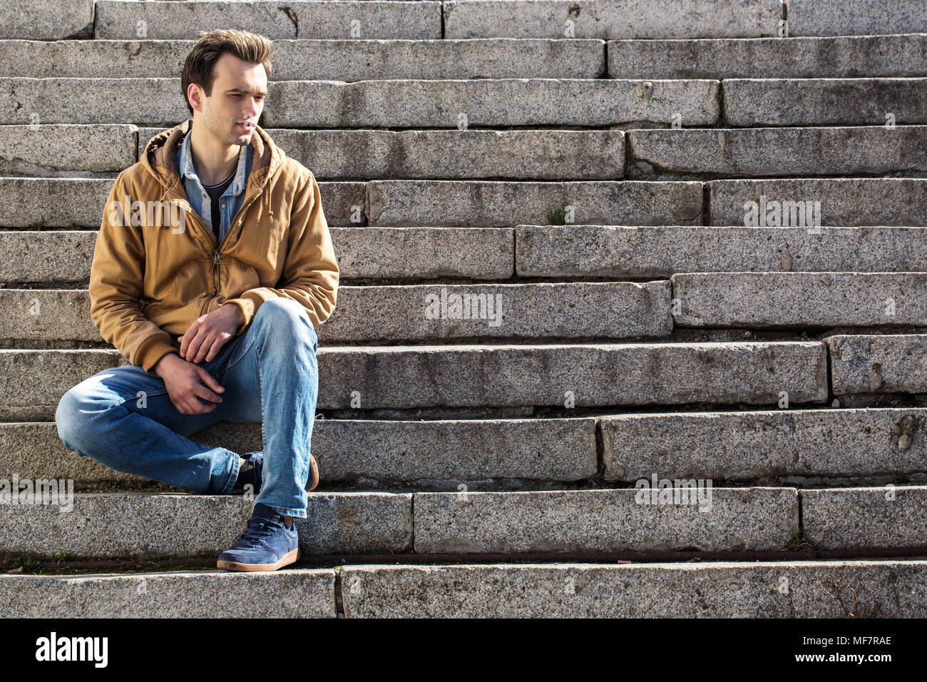 Young guy sits on steps hi-res stock photography and images - Alamy