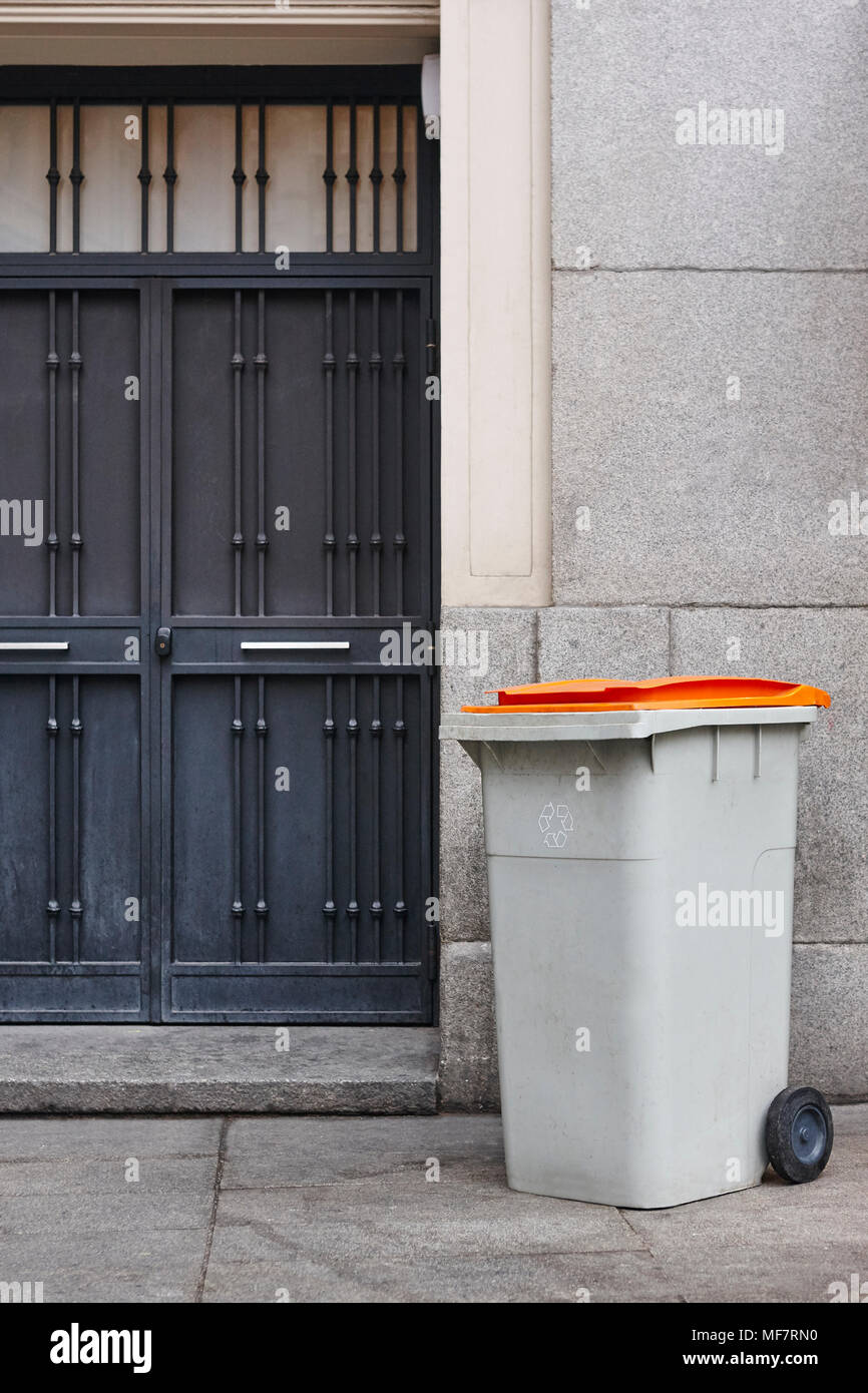 Garbage can on an urban building entrance door. Clean environment Stock ...