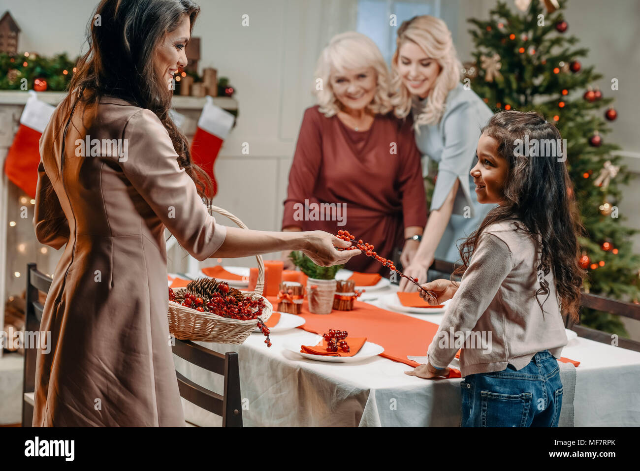 women decorating christmas table Stock Photo - Alamy