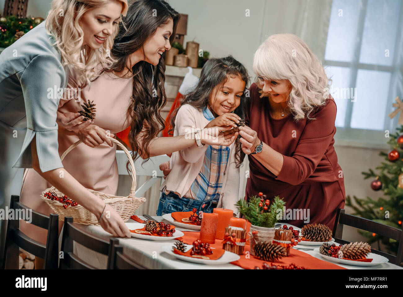 women decorating christmas table Stock Photo - Alamy