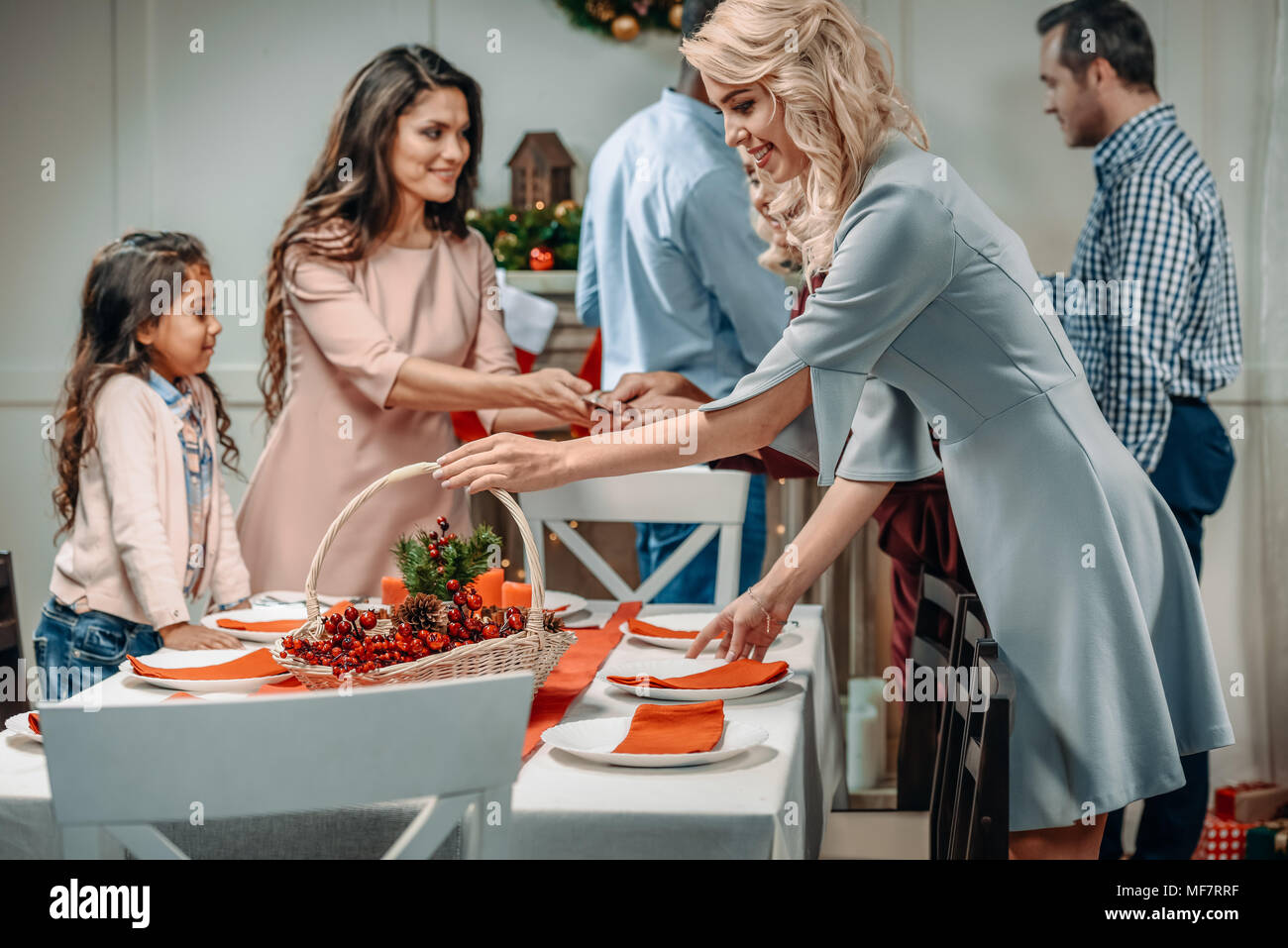 women decorating christmas table Stock Photo - Alamy