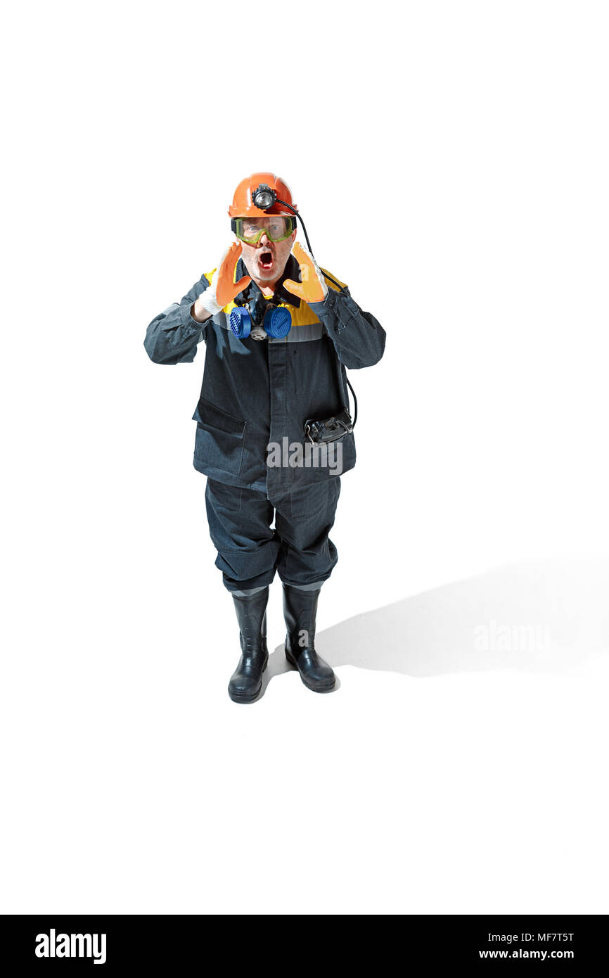 The studio shot of senior bearded male miner standing at the camera on ...