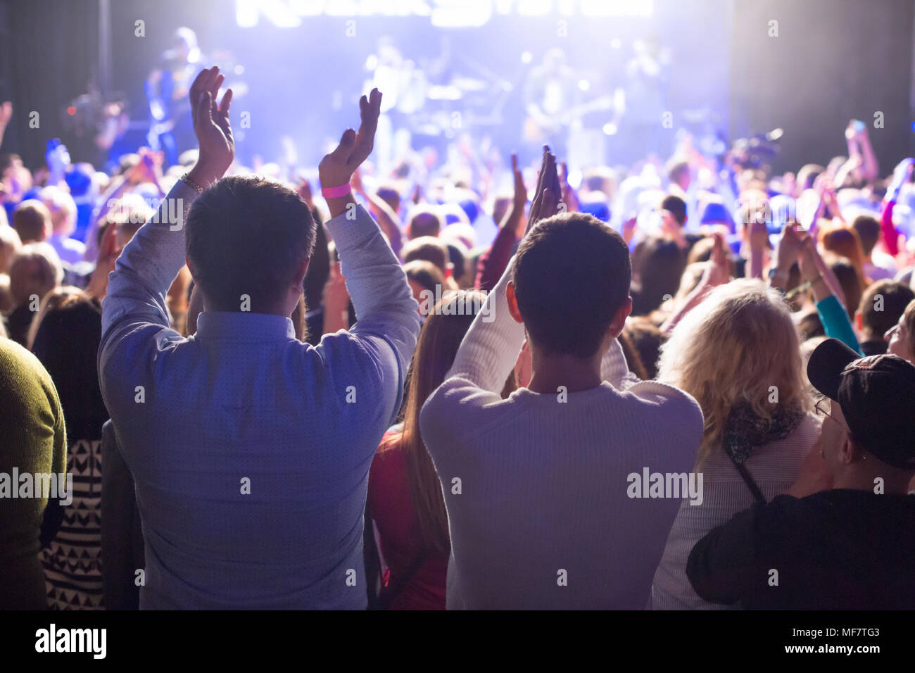 The audience watching the concert on stage in big concert club Stock ...