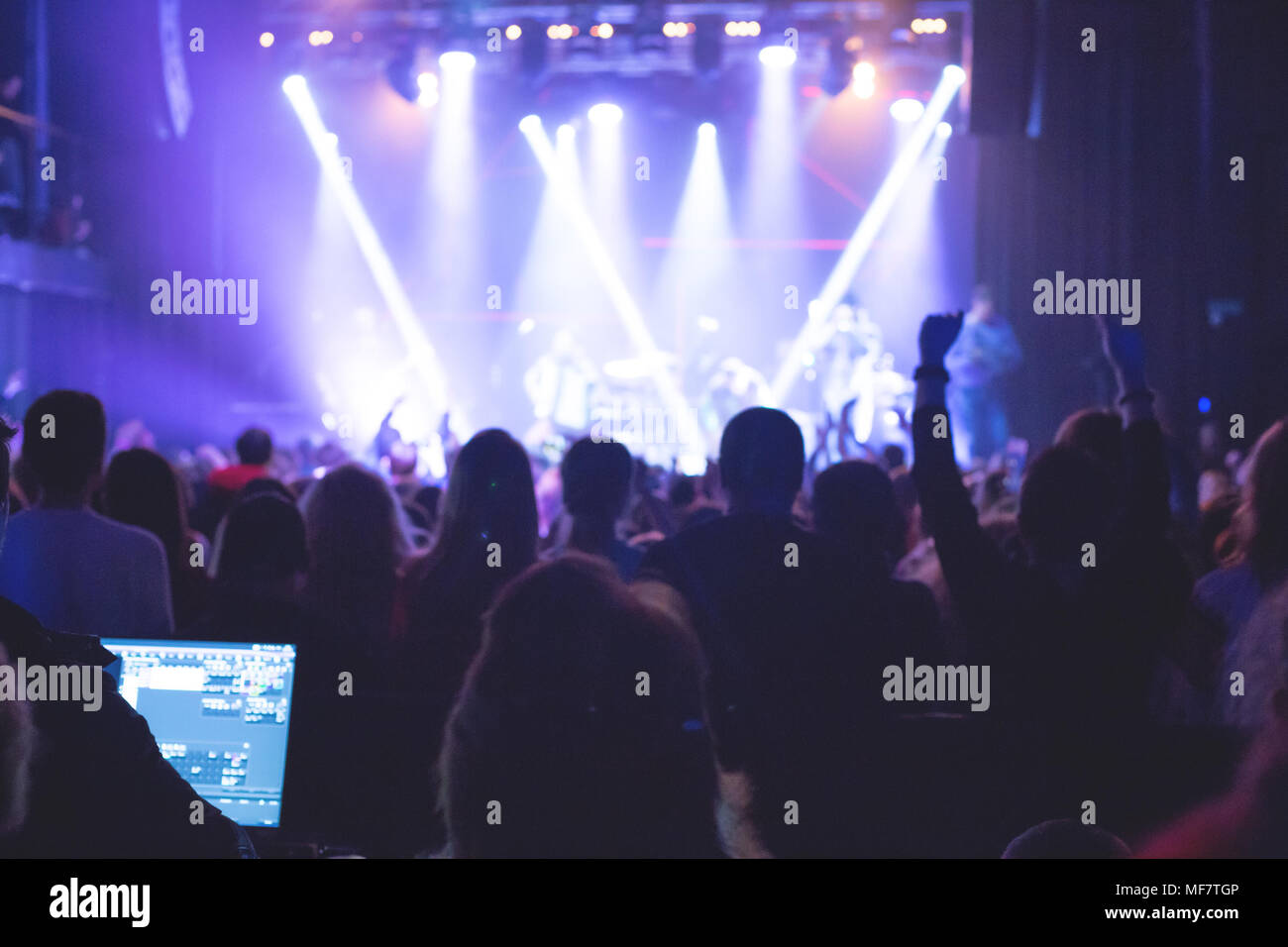 The audience watching the concert on stage in big concert club Stock ...