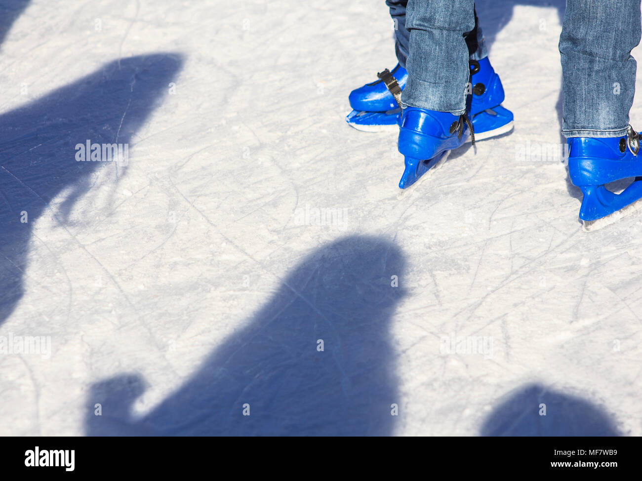 People skating with blue skates on the ice area Stock Photo - Alamy