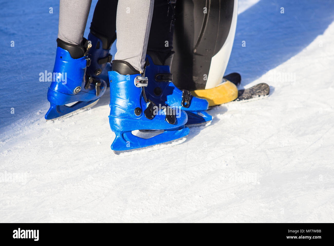 People skating with blue skates on the ice area Stock Photo - Alamy