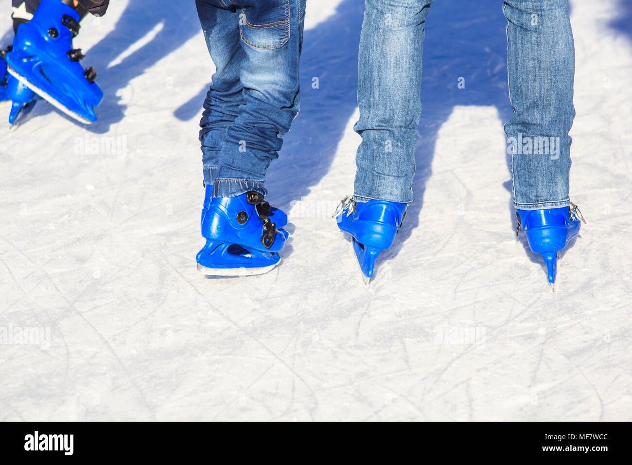 People skating with blue skates on the ice area Stock Photo - Alamy