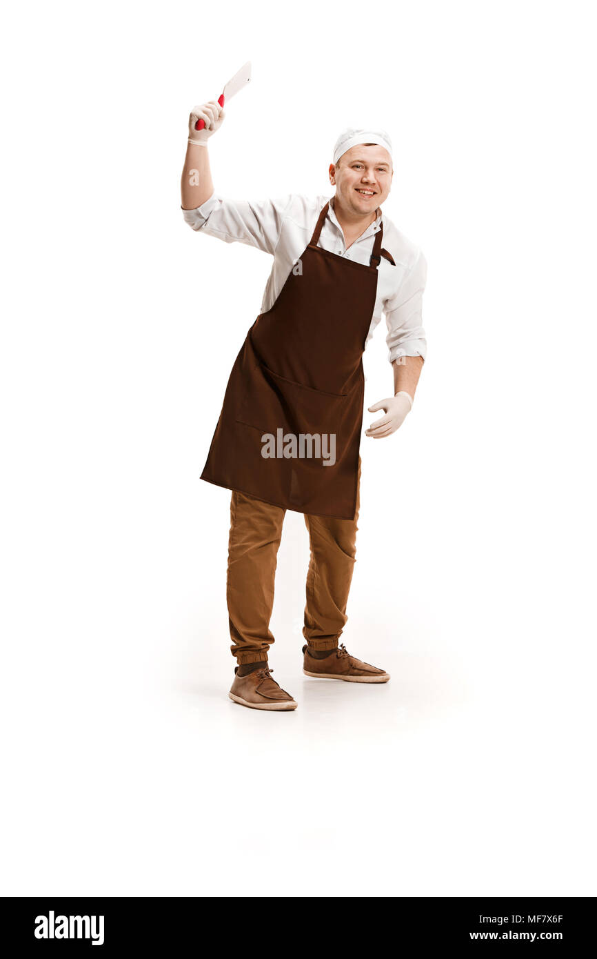 Smiling butcher posing with a cleaver isolated on white background ...