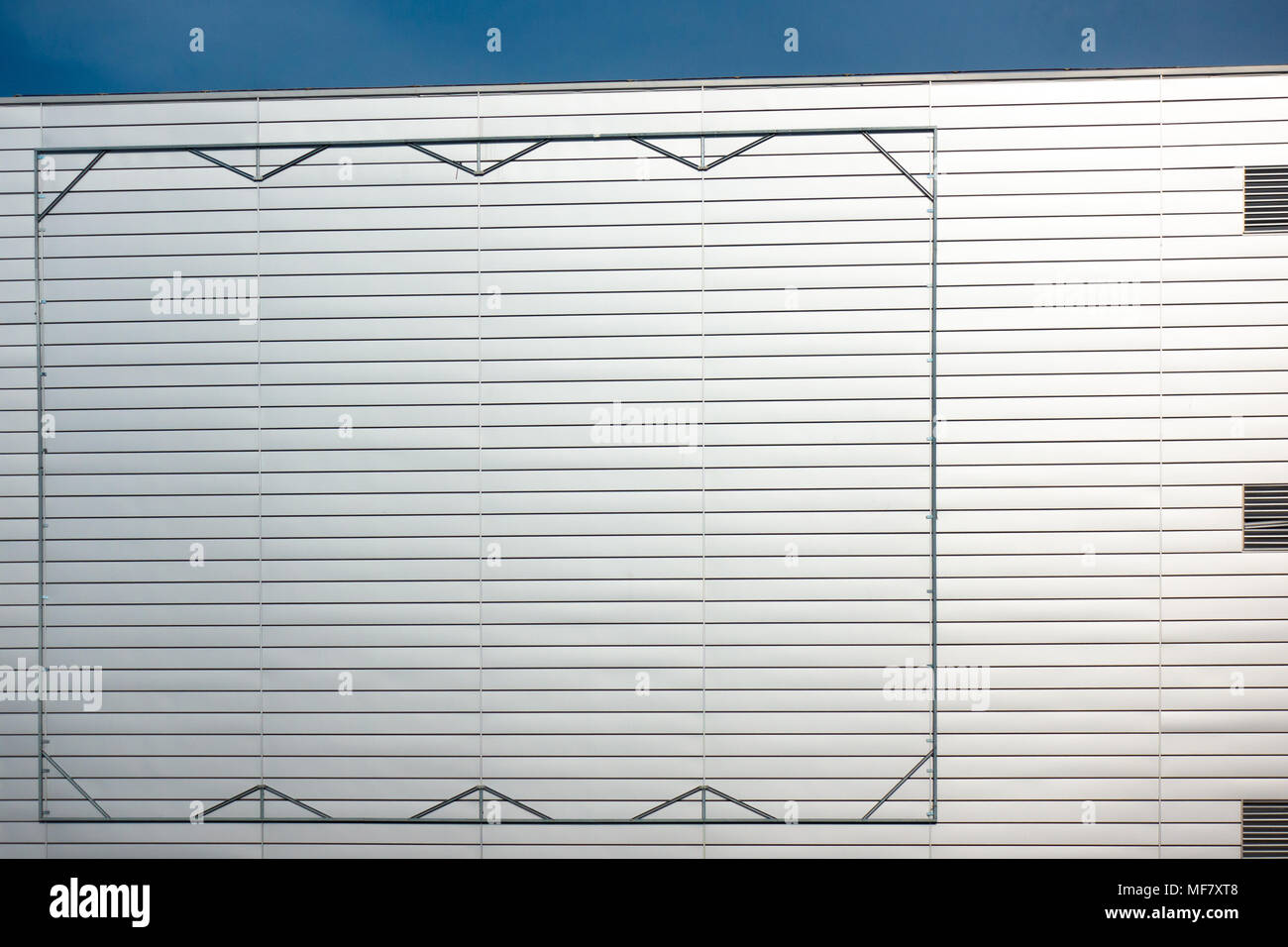 Blank billboard steel frame on facade of industrial style building ...