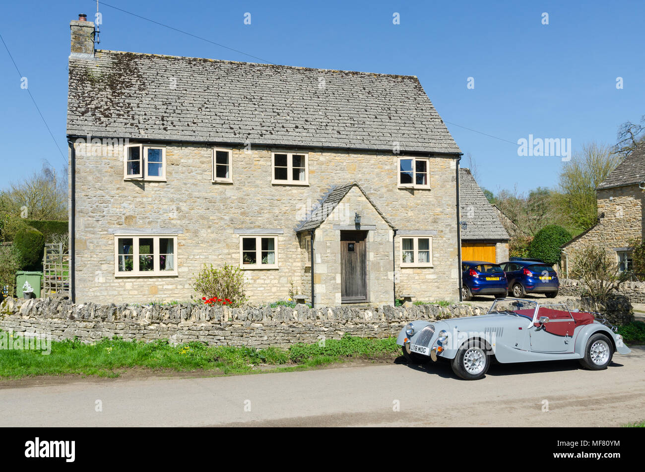 Smart cottage with Morgan motor car parked outside in the pretty ...