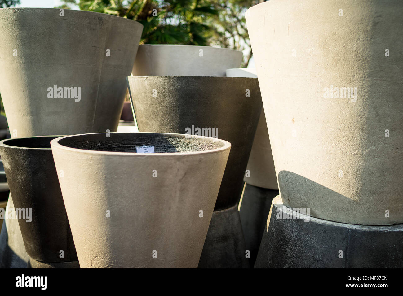 Large grey plant pots stacked at a plant nursery Stock Photo - Alamy