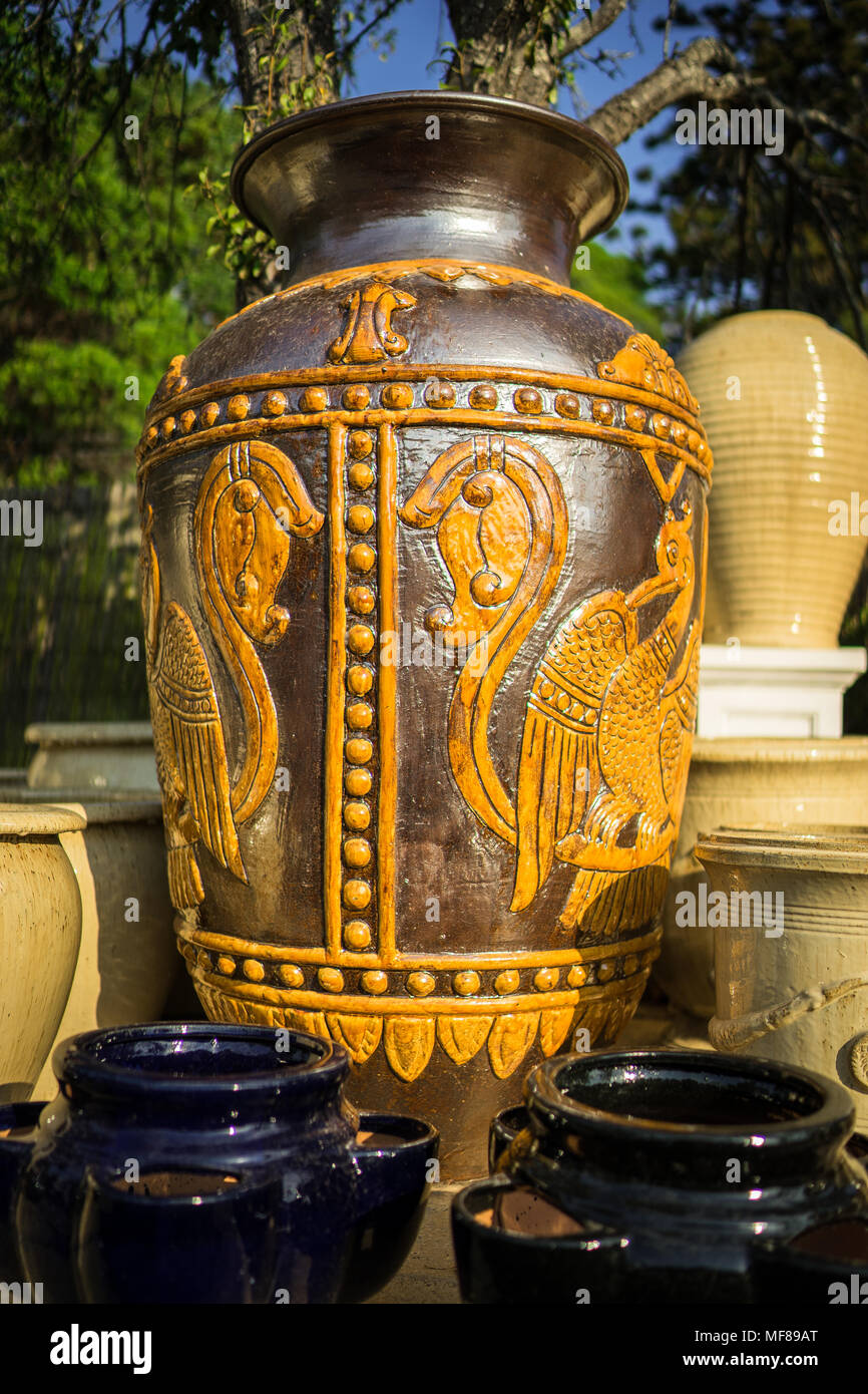 Large bronze and grey plant pots stacked at a plant nursery Stock Photo ...