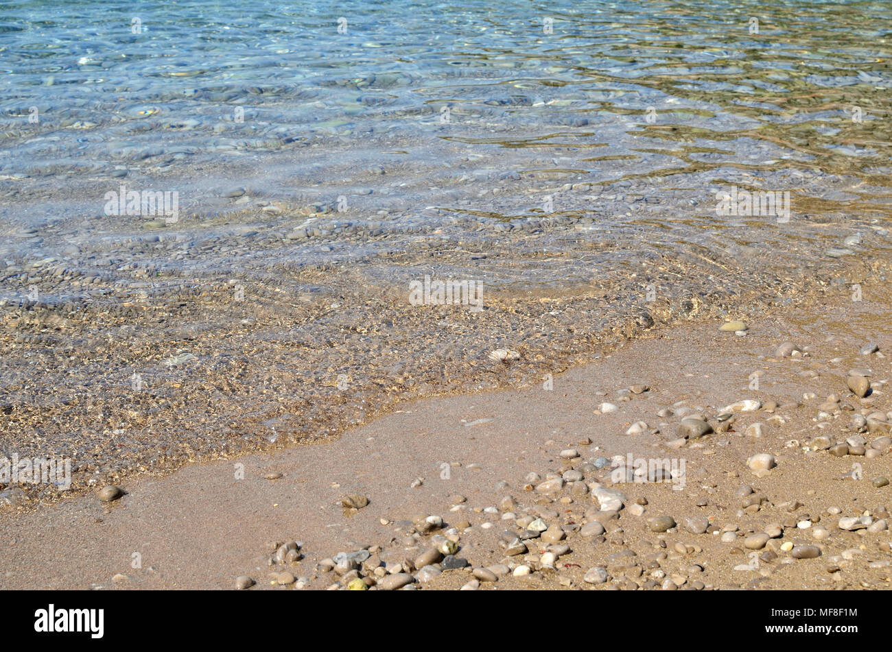 Sea shallow, small wave and wet sand of a beach Stock Photo - Alamy
