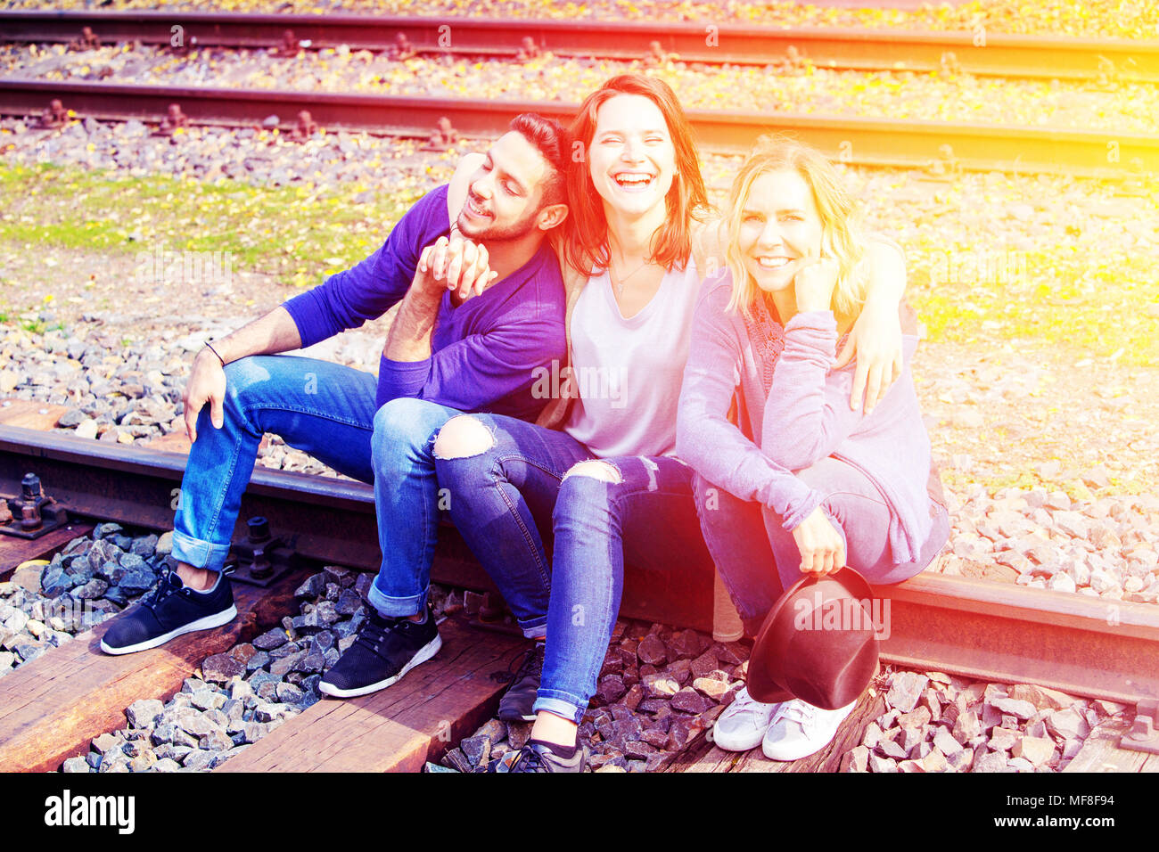 Three male friends sitting outside hi-res stock photography and images ...