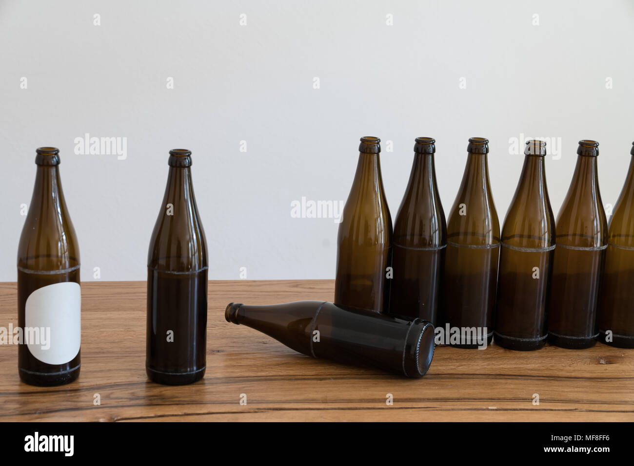 many empty brown beer bottles on a brown wooden table with plenty of ...