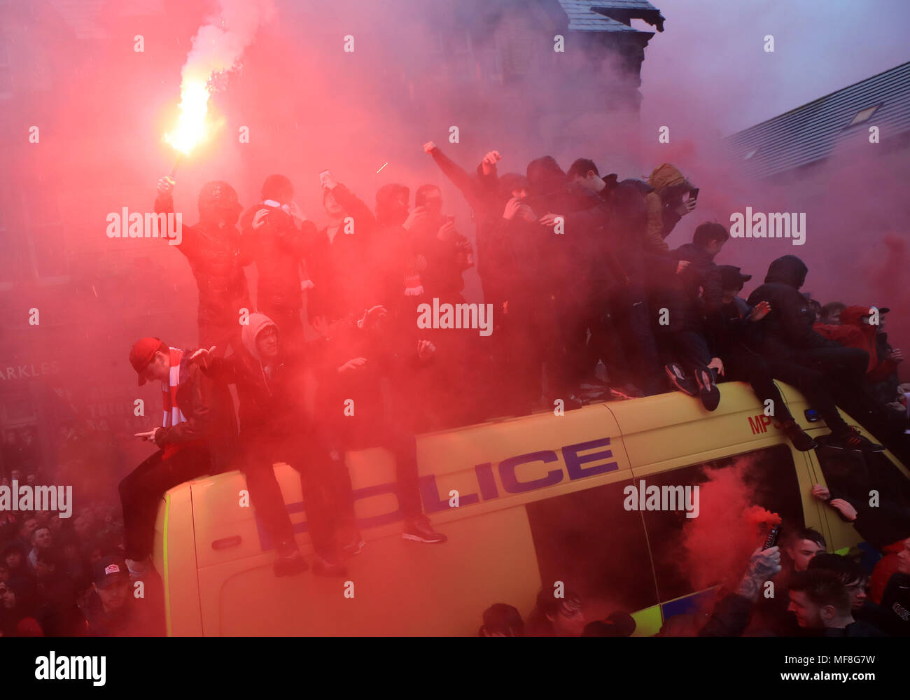 Fans on top of a Police van and flares being let off before the UEFA ...