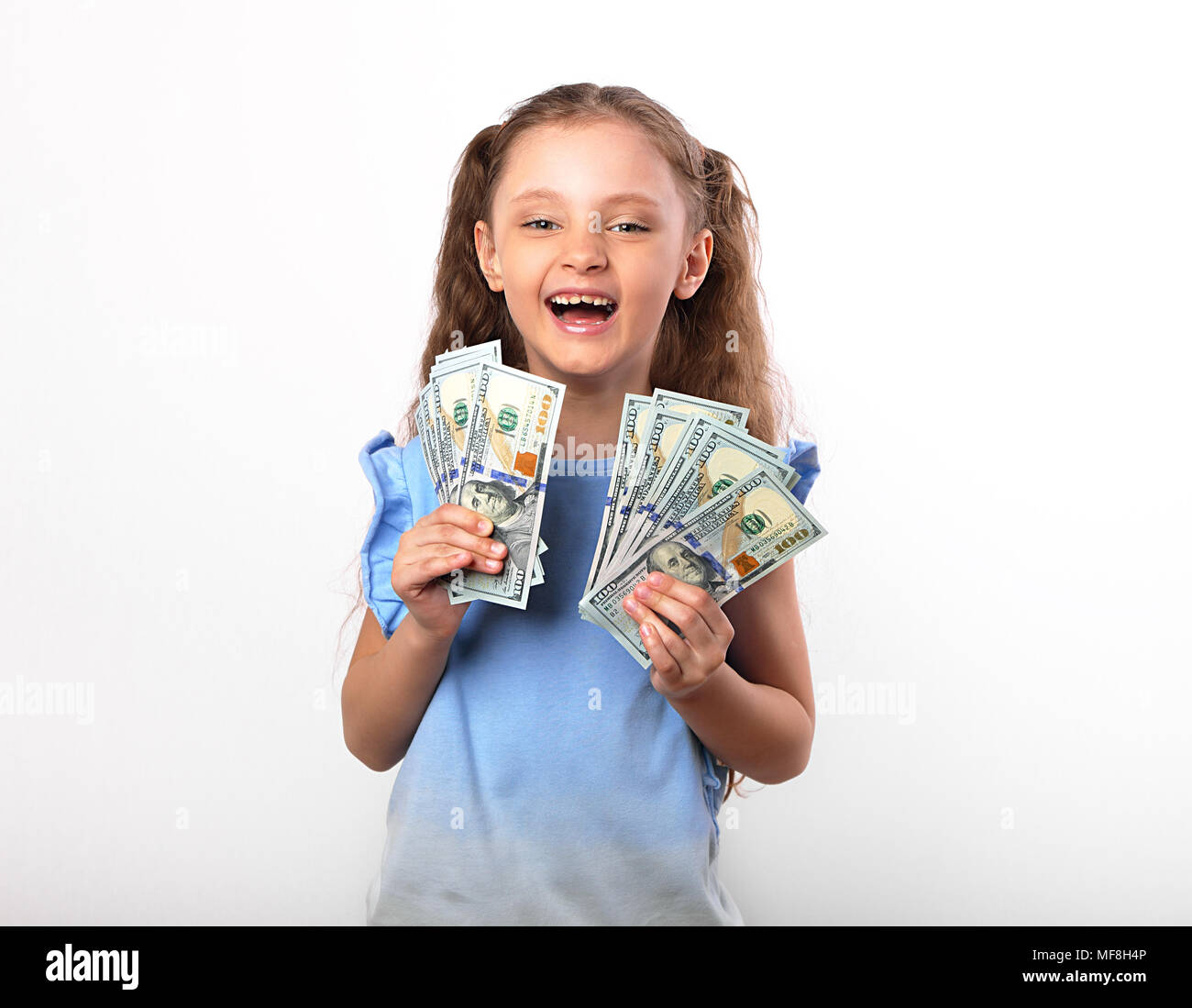 Happy laughing rich kid girl holding money in the hand on white ...