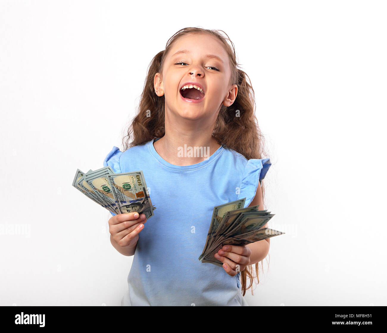 Happy laughing rich kid girl holding money in thr hand on white ...