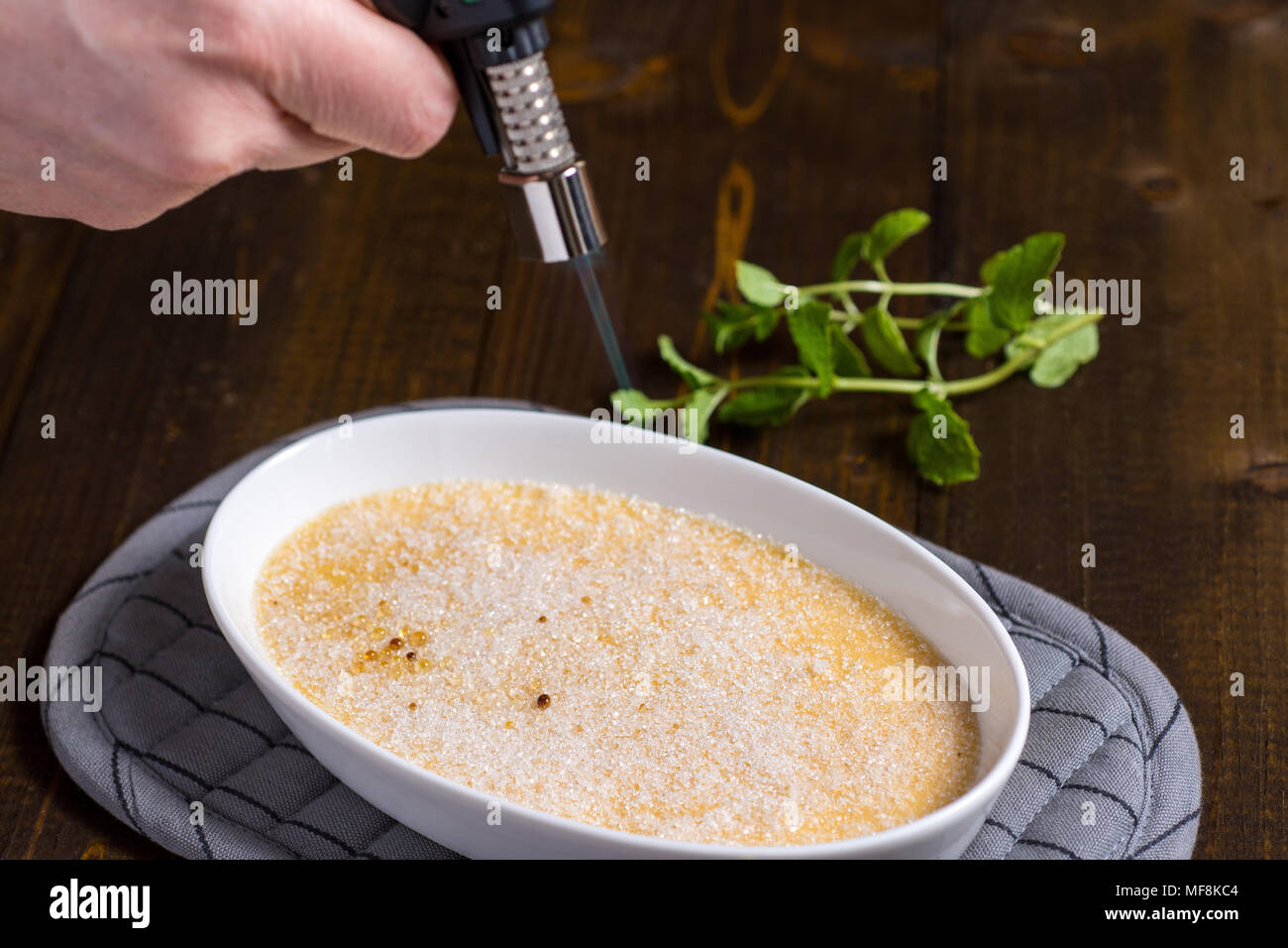 Creme Brulee Caramelizing Using a Torch Stock Photo - Alamy