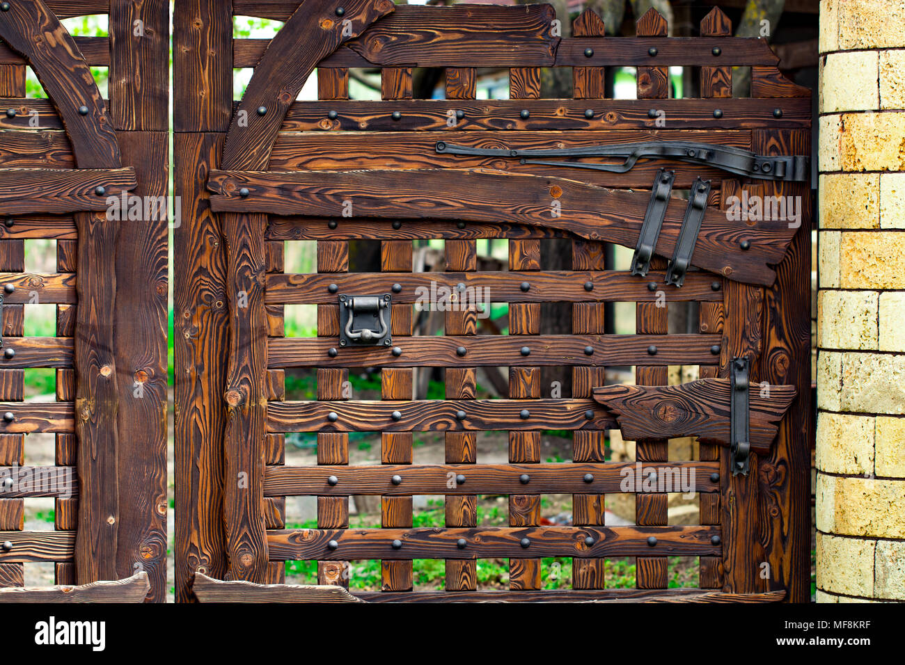 wooden gate with wrought iron elements close up Stock Photo - Alamy