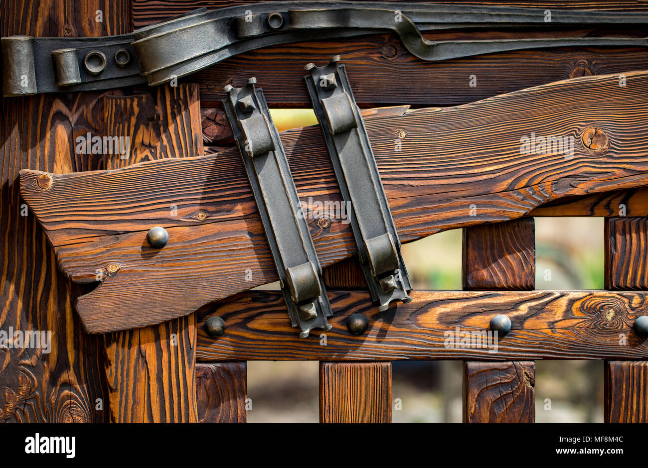 wooden gate with wrought iron elements close up Stock Photo - Alamy