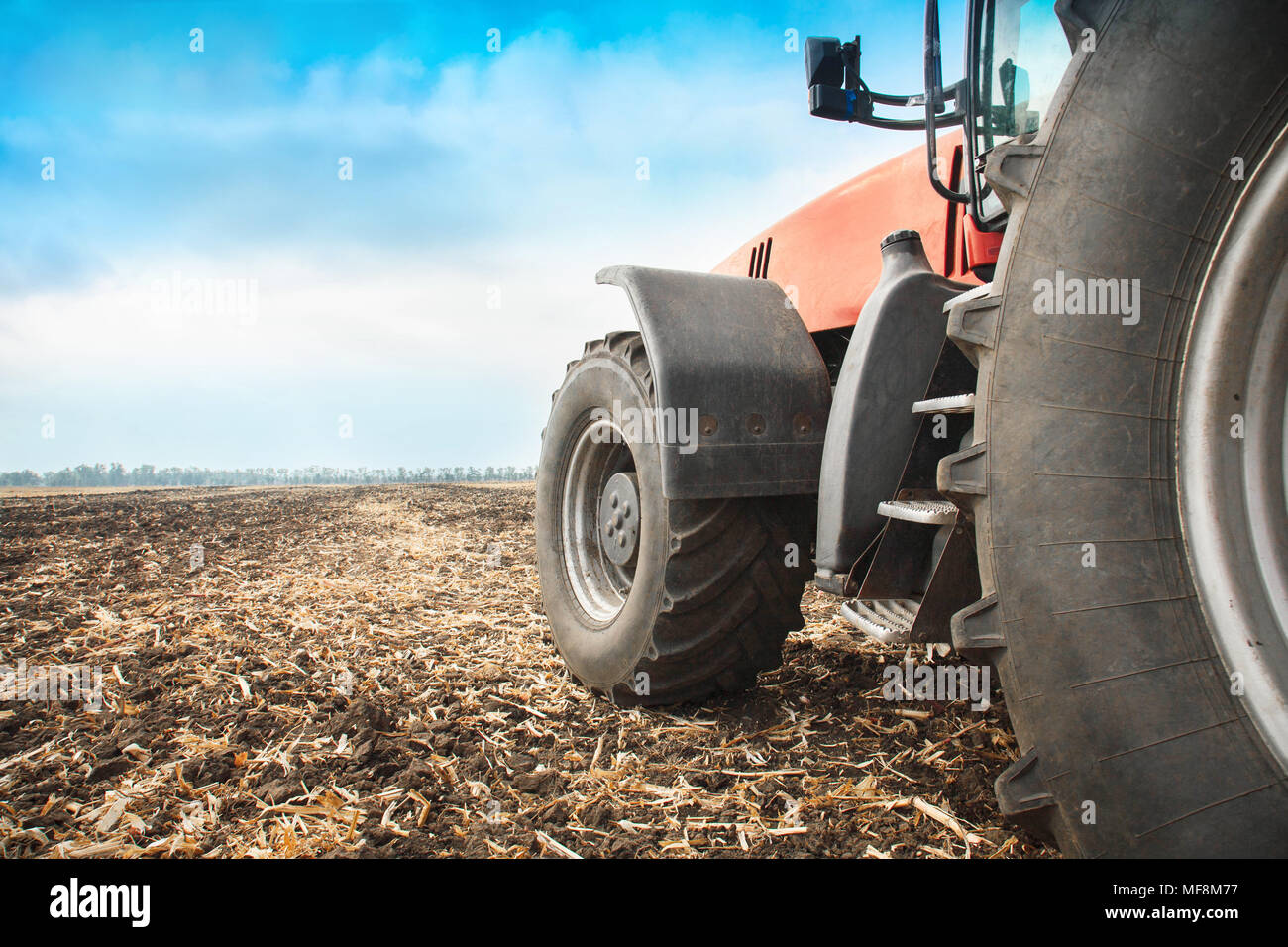 Modern red tractor in the field close-up on a bright sunny day Stock ...