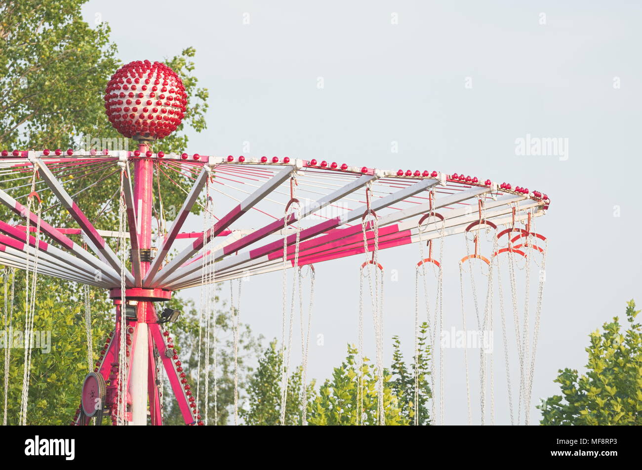 White and Red Carousel Top Closeup with Trees and Sky Stock Photo - Alamy