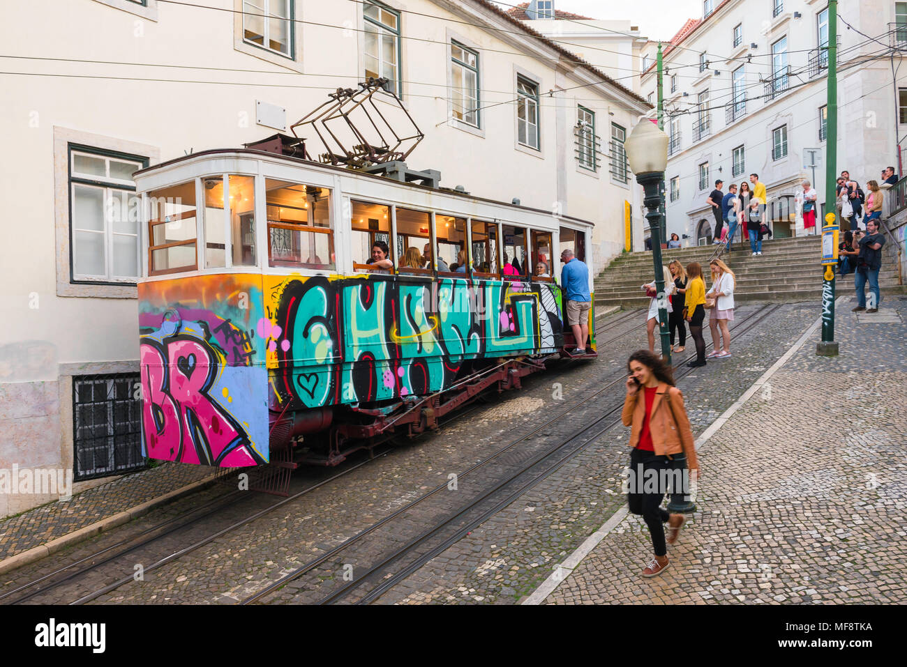 Tram Lisbon street, view of a colorfully graffitied tram car on the ...