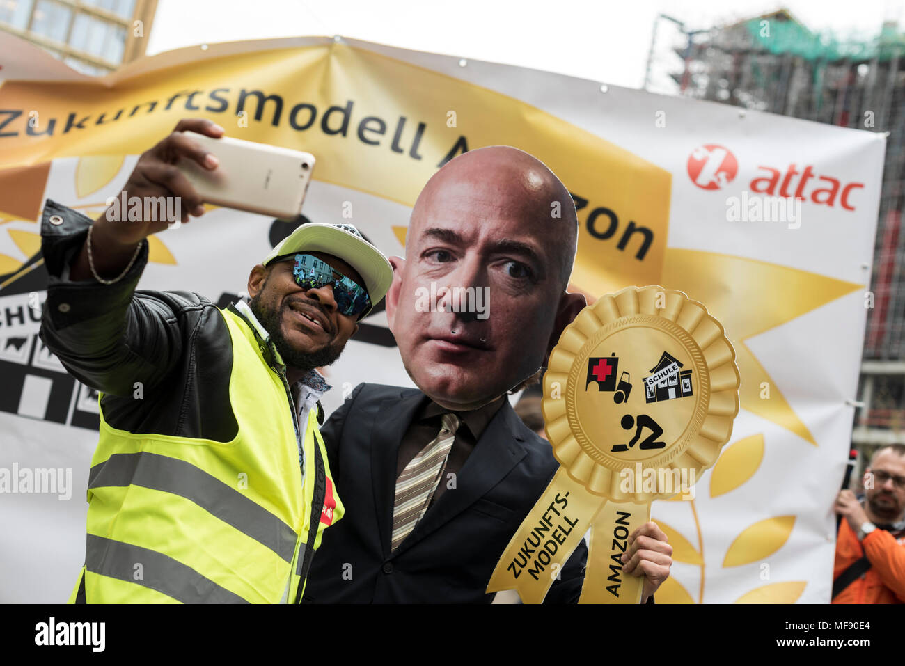 A protester makes a selfie with a demonstrator wearing a Jeff Bezo's ...