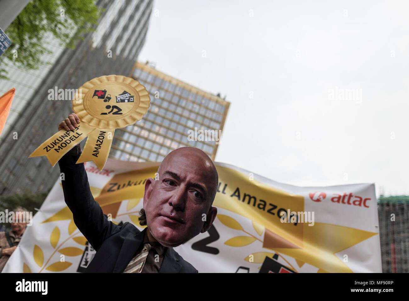 Berlin, Germany. 24th Apr, 2018. A demonstrator of a Jeff Bezos holds a ...