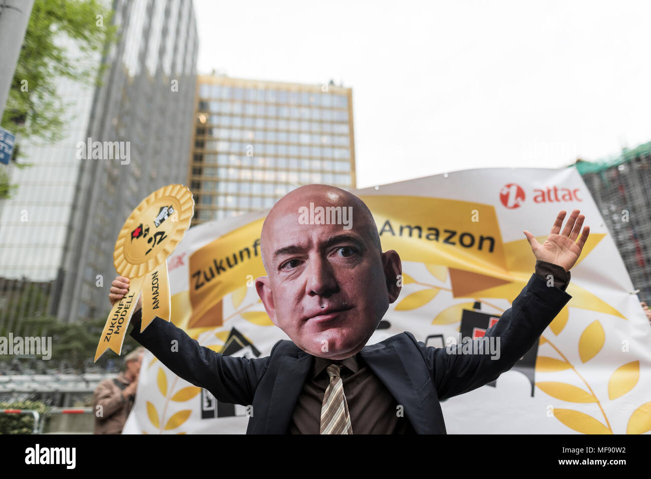 Berlin, Germany. 24th Apr, 2018. A demonstrator of a Jeff Bezos holds a ...