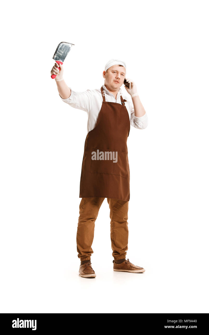 Smiling butcher posing with a cleaver isolated on white background ...