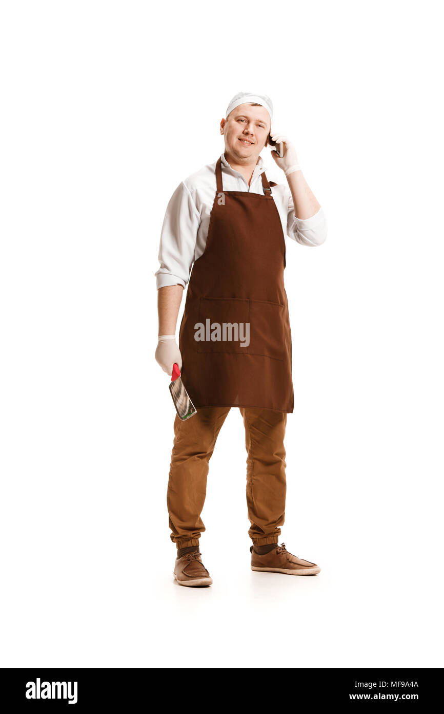 Smiling butcher posing with a cleaver isolated on white background ...